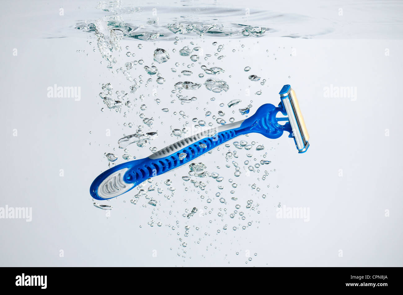 Disposable razor submerged in water Stock Photo - Alamy