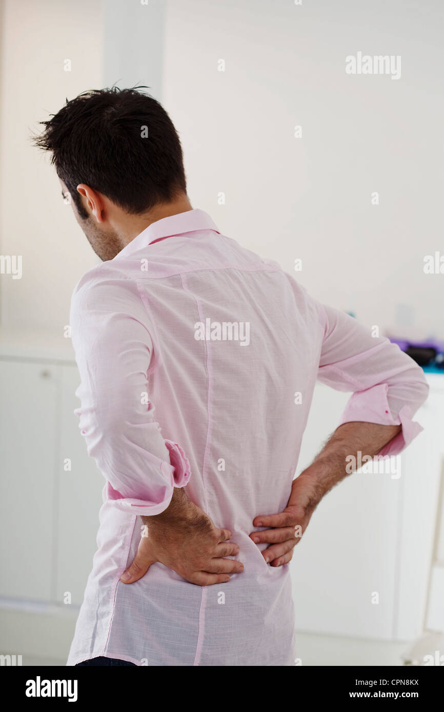 LOWER BACK PAIN IN A MAN Stock Photo - Alamy