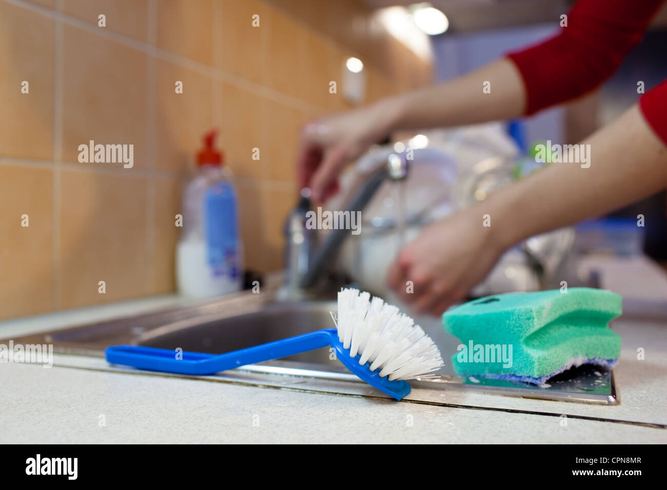 Washing of the dishes - woman hands rinsing dishes under running water ...