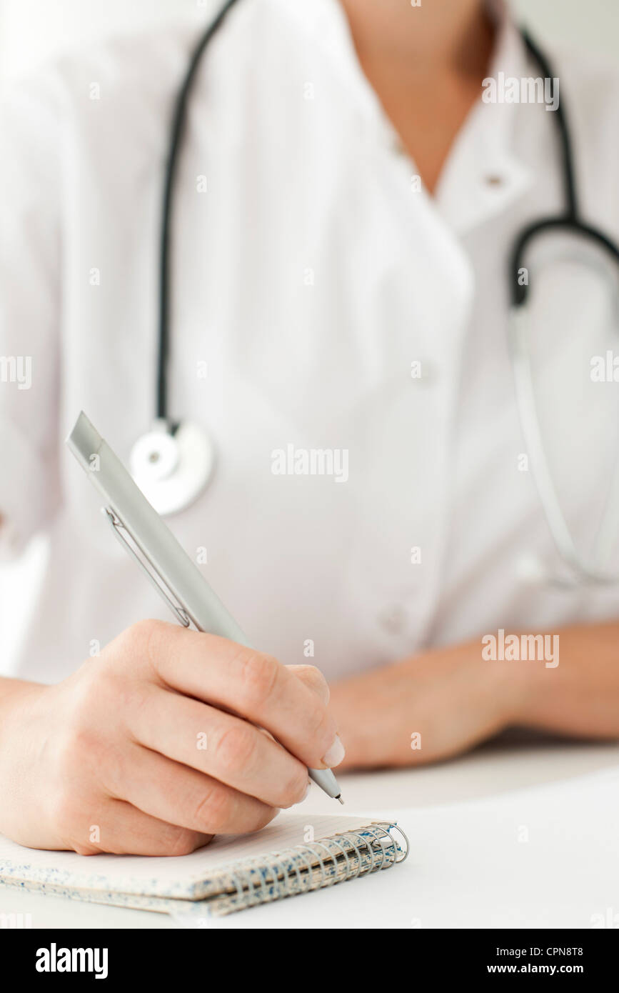Physician writing in notepad hi-res stock photography and images - Alamy
