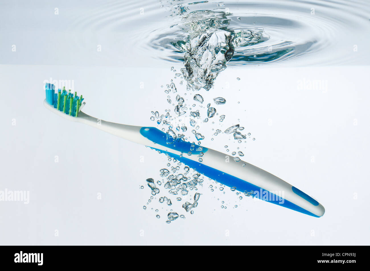 Toothbrush submerged in water Stock Photo - Alamy