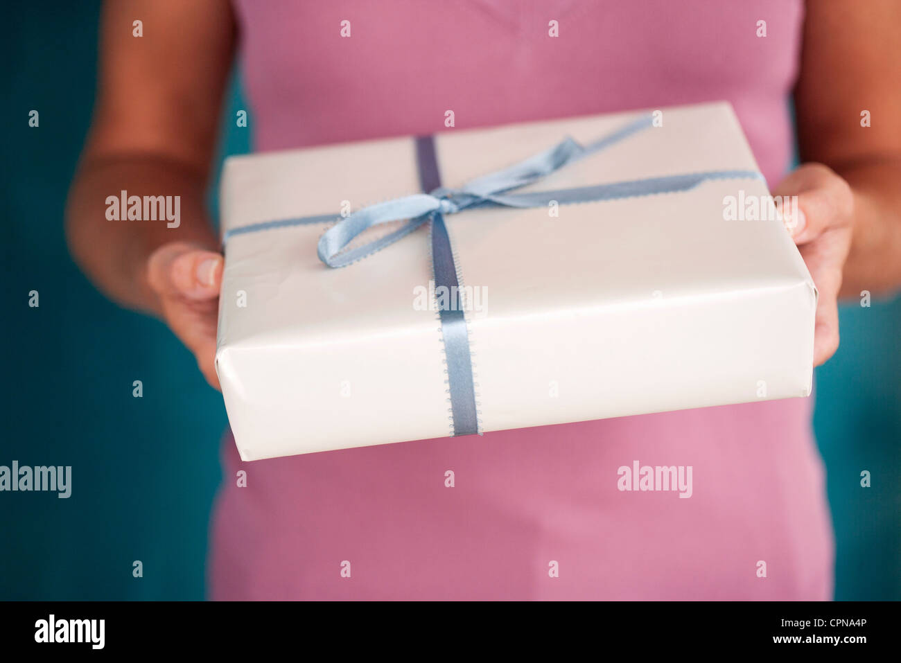 Woman holds out gift in hi-res stock photography and images - Alamy