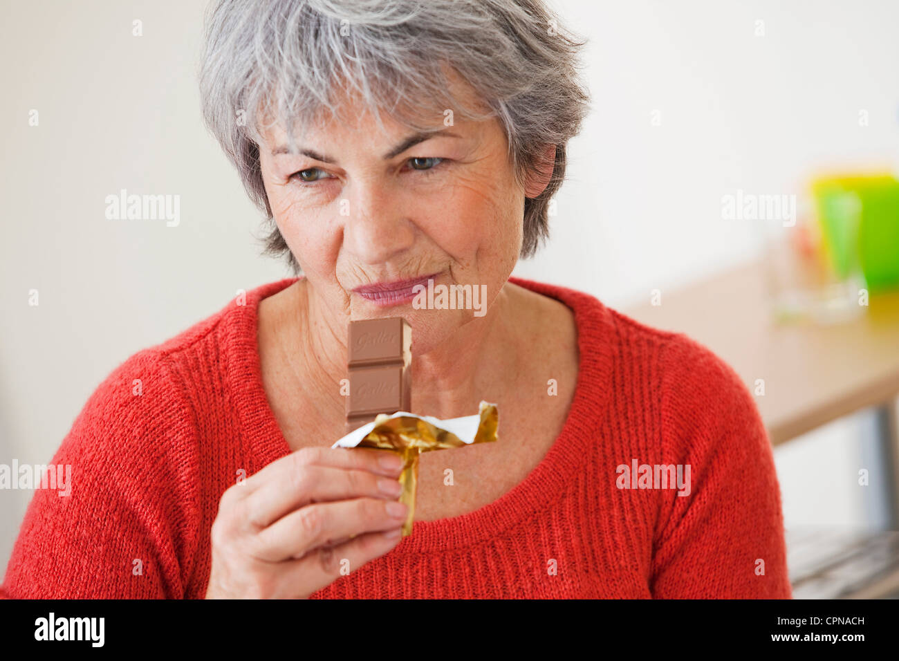 ELDERLY PERSON EATING SWEETS Stock Photo - Alamy
