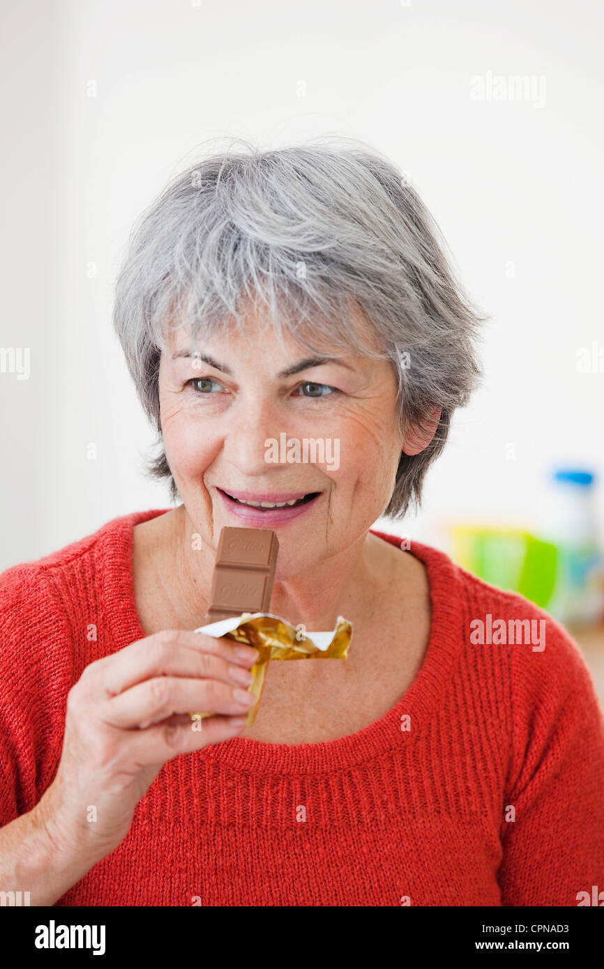 ELDERLY PERSON EATING SWEETS Stock Photo - Alamy
