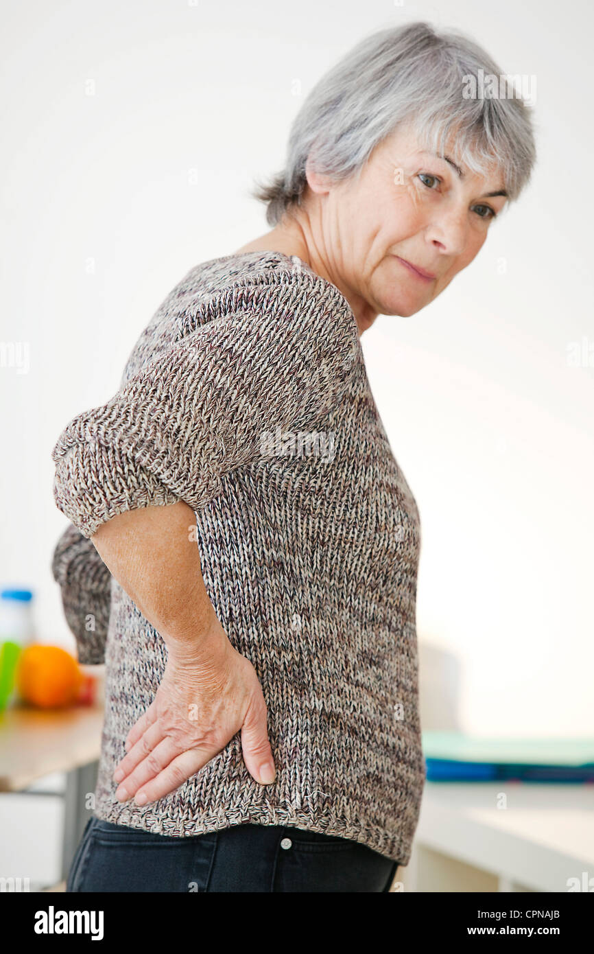 LOWER BACK PAIN IN ELDERLY PERS Stock Photo - Alamy