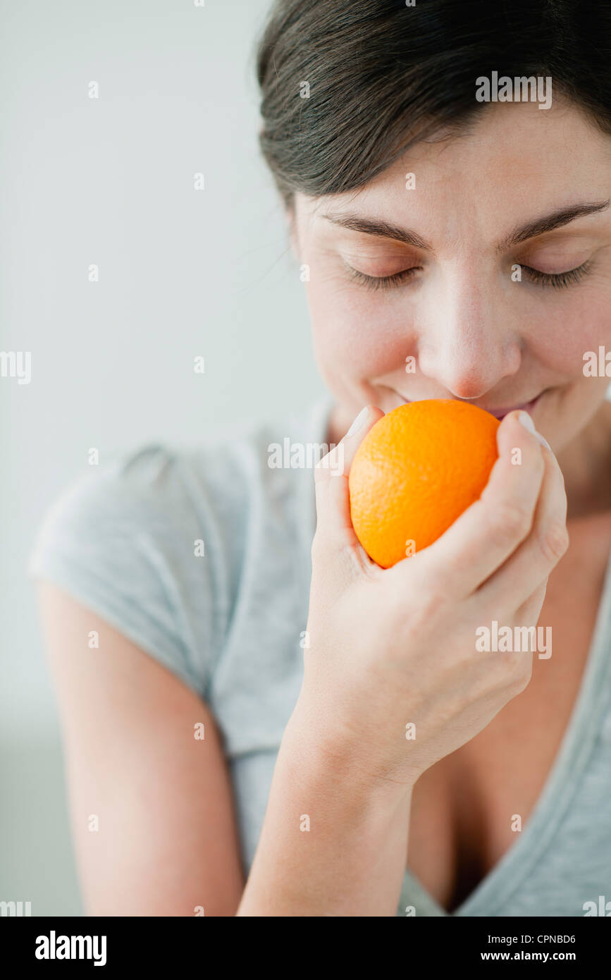 Woman smelling fresh orange Stock Photo - Alamy