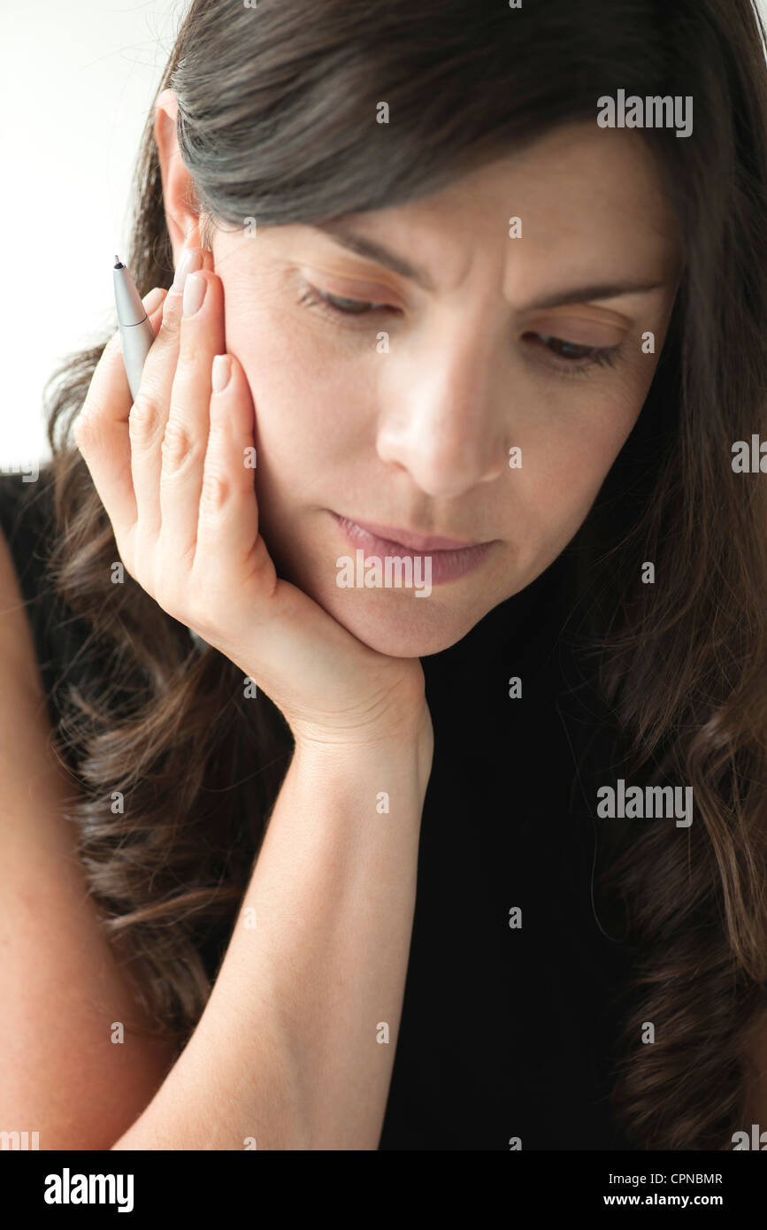 Mid-adult woman frowning Stock Photo - Alamy