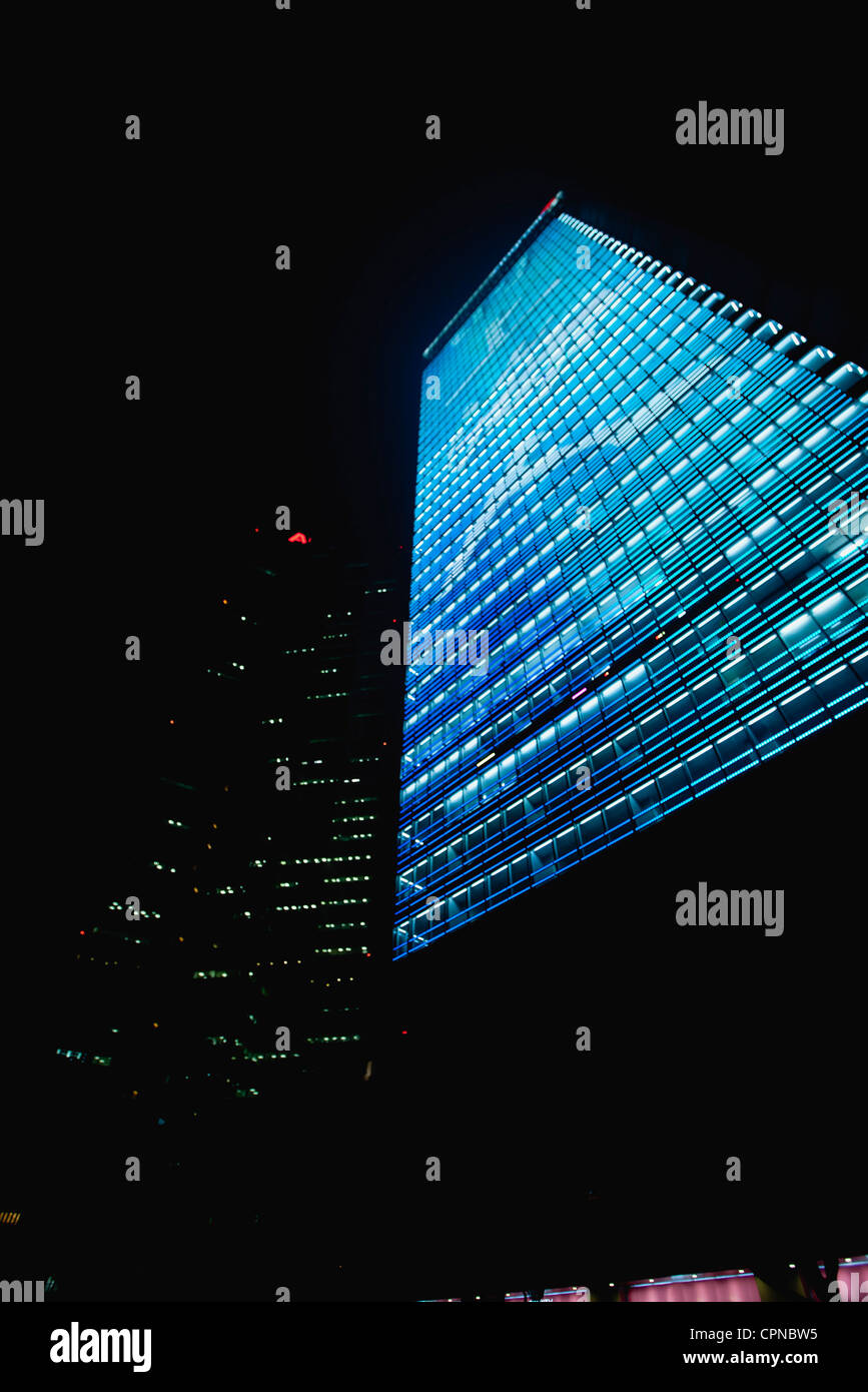 Building illuminated with blue lights at night, Shanghai, China Stock ...