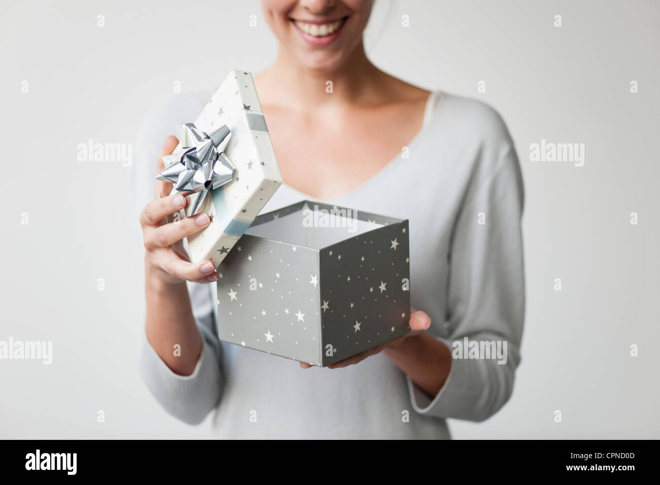 Woman opening gift box, cropped Stock Photo - Alamy