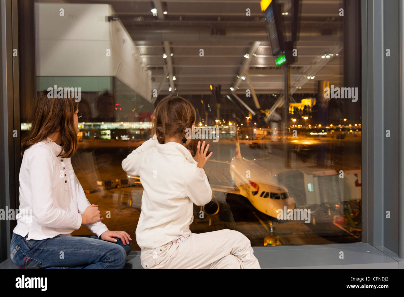 Children watch from airport terminal window as flight crew prepare ...