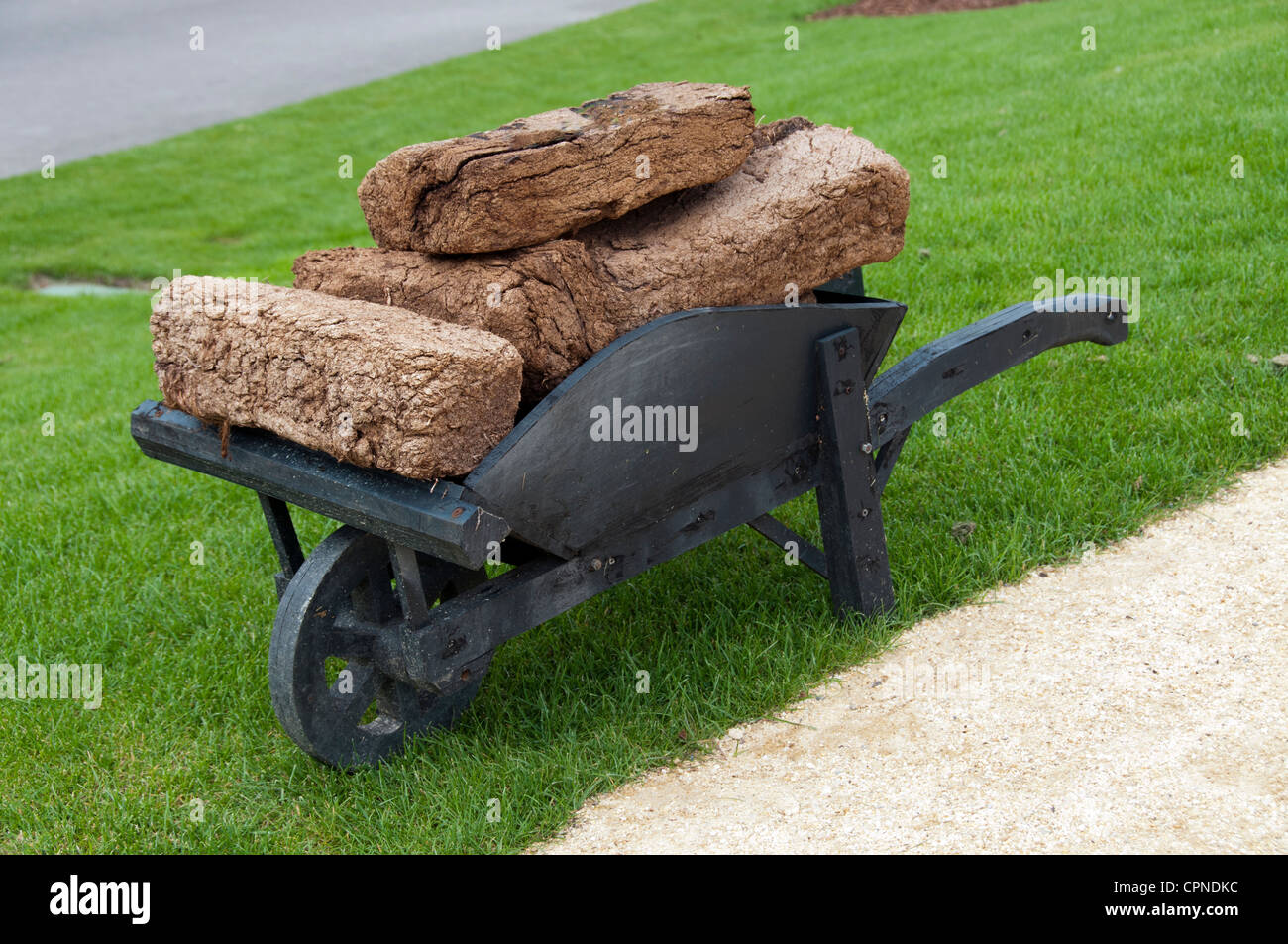 landscape with wheelbarrow with peat Stock Photo - Alamy