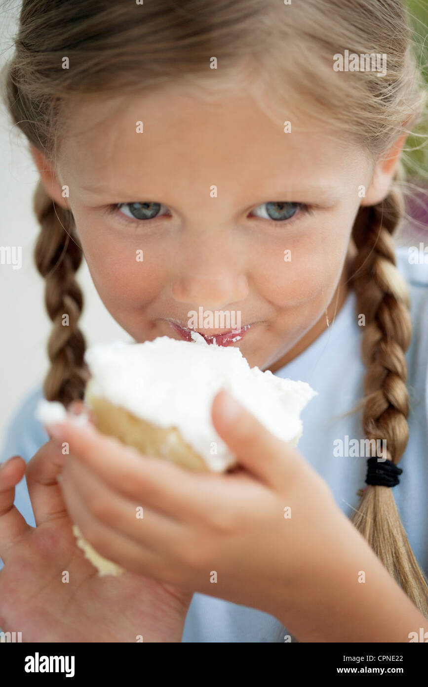 Girl eating cake Stock Photo - Alamy