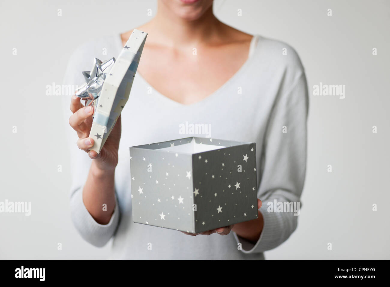 Woman opening gift box, cropped Stock Photo - Alamy