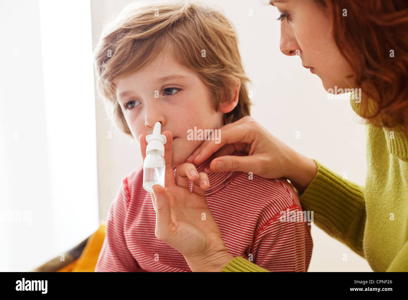 CHILD USING NOSE SPRAY Stock Photo - Alamy
