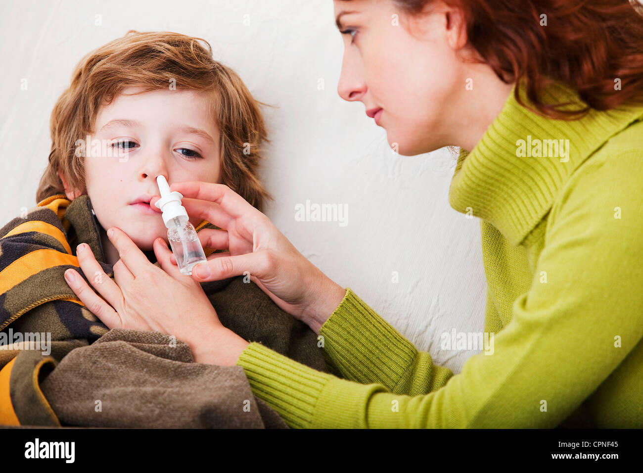 CHILD USING NOSE SPRAY Stock Photo - Alamy
