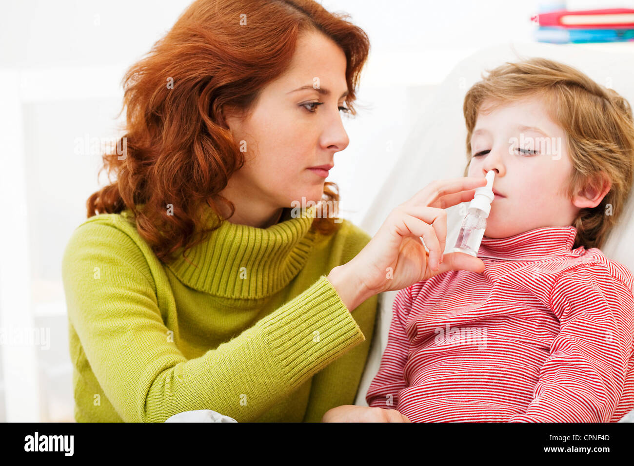 CHILD USING NOSE SPRAY Stock Photo - Alamy