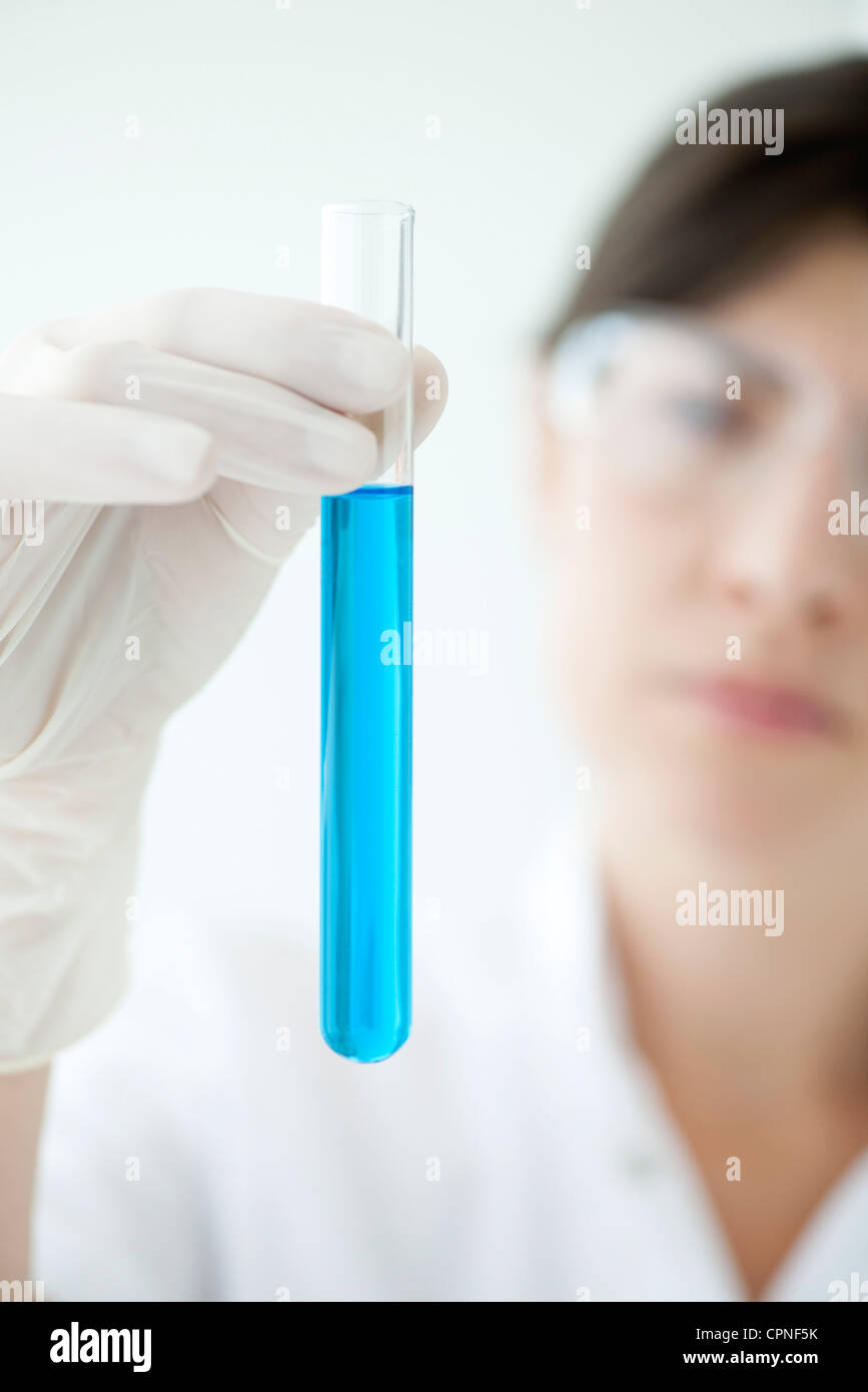 Scientist holding test tube containing blue liquid Stock Photo - Alamy