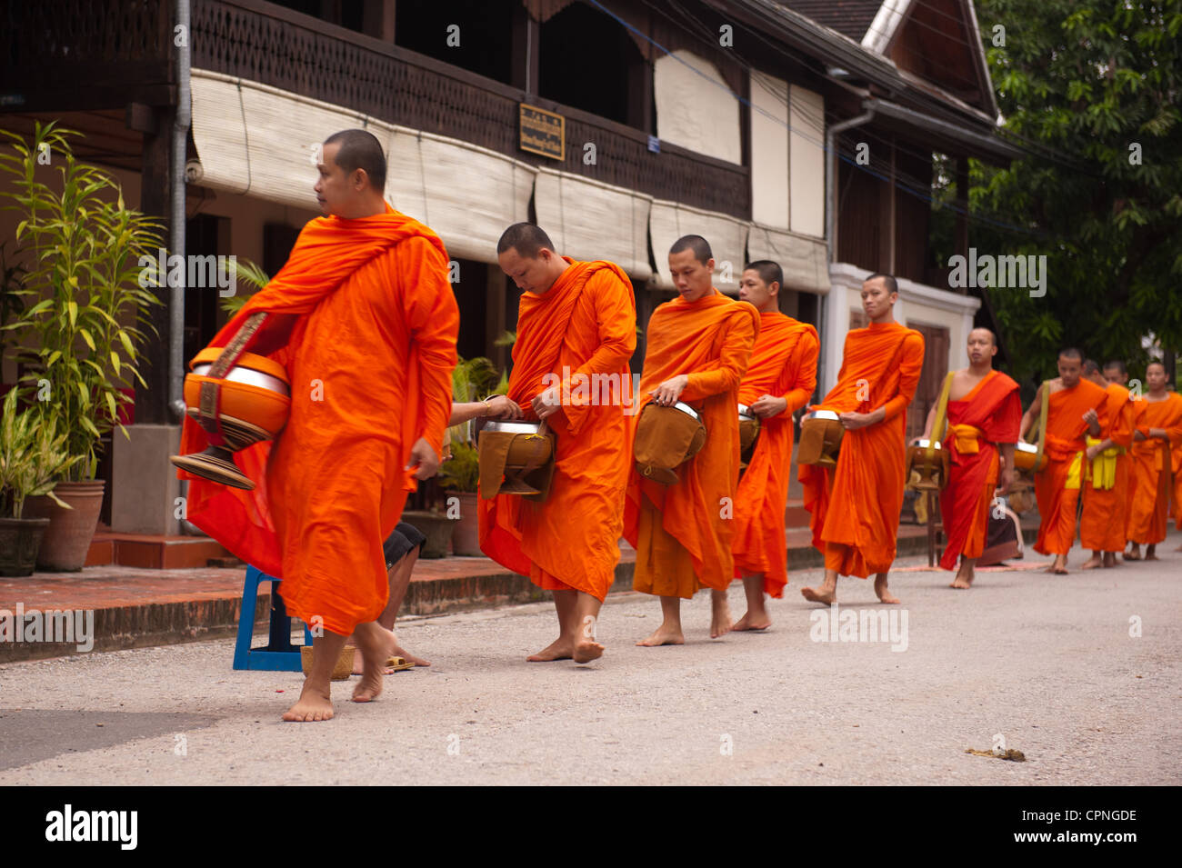 Collecting alms of rice hi-res stock photography and images - Alamy