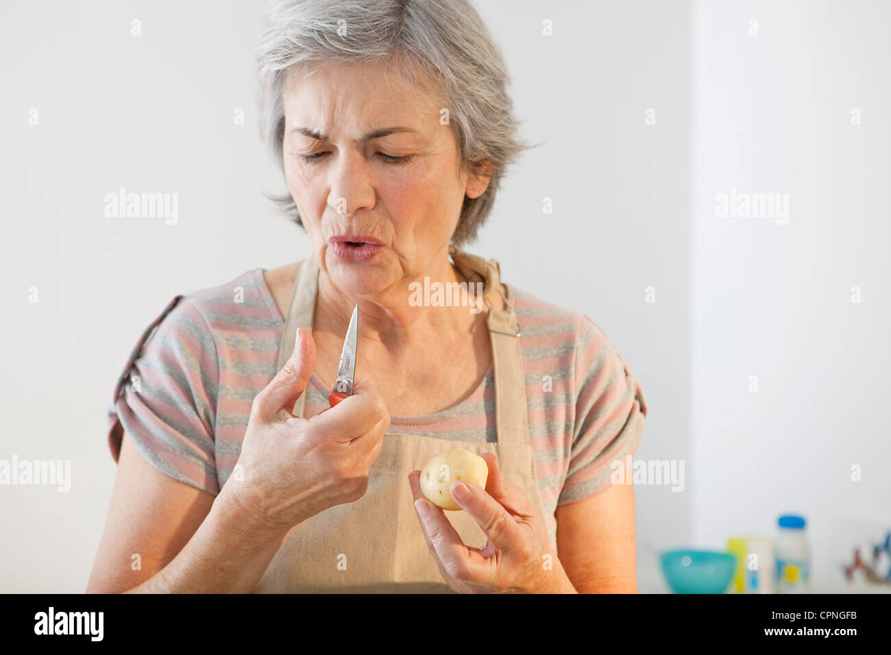ELDERLY PERSON IN KITCHEN Stock Photo - Alamy
