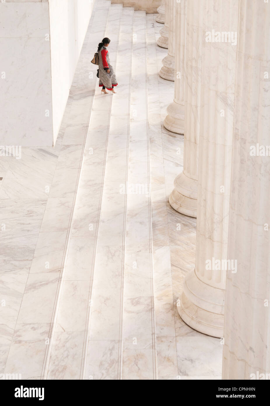 person climbing steps next to columns Stock Photo - Alamy
