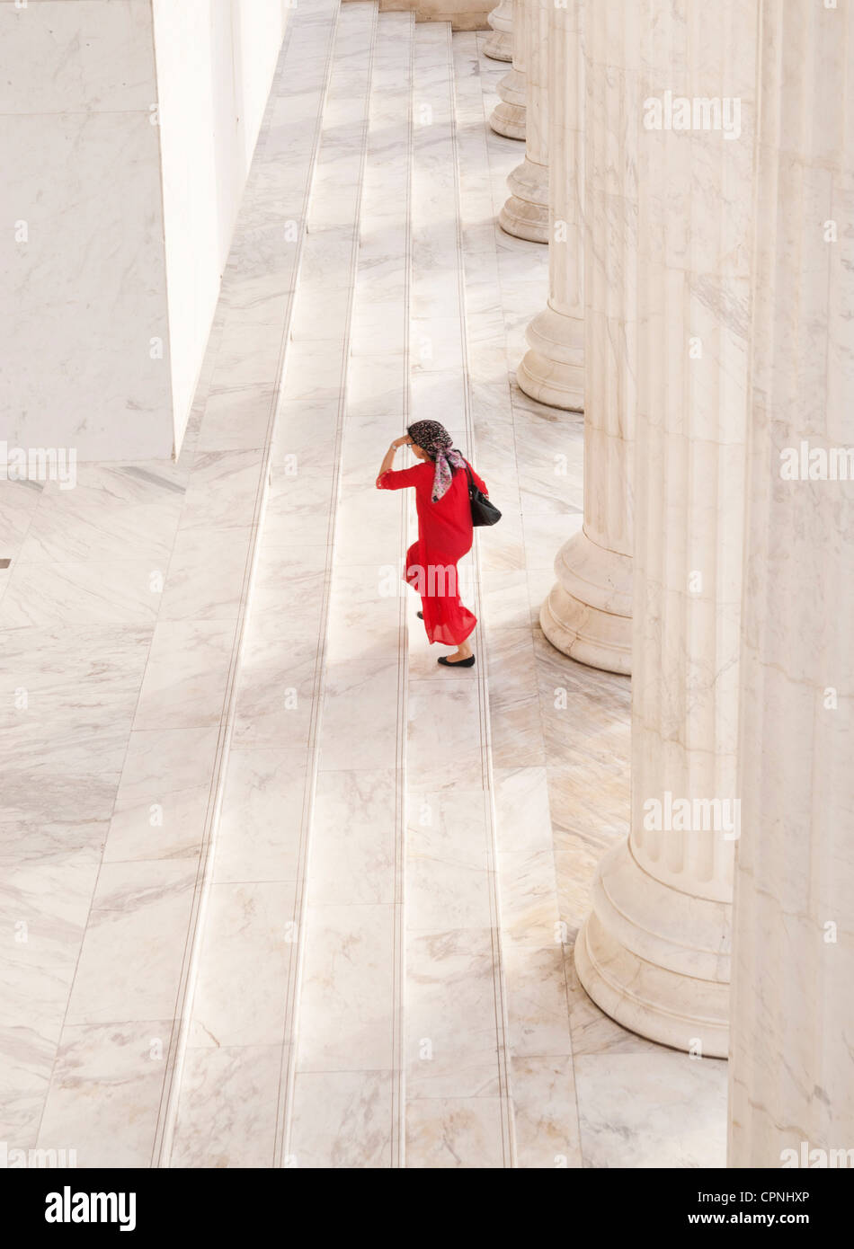 person climbing steps next to columns Stock Photo - Alamy