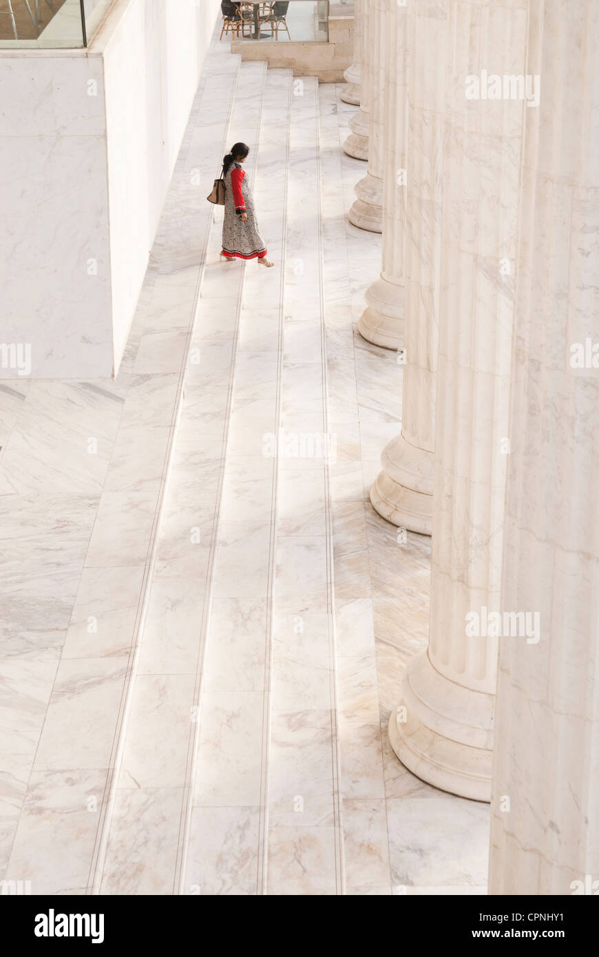person climbing steps next to columns Stock Photo - Alamy