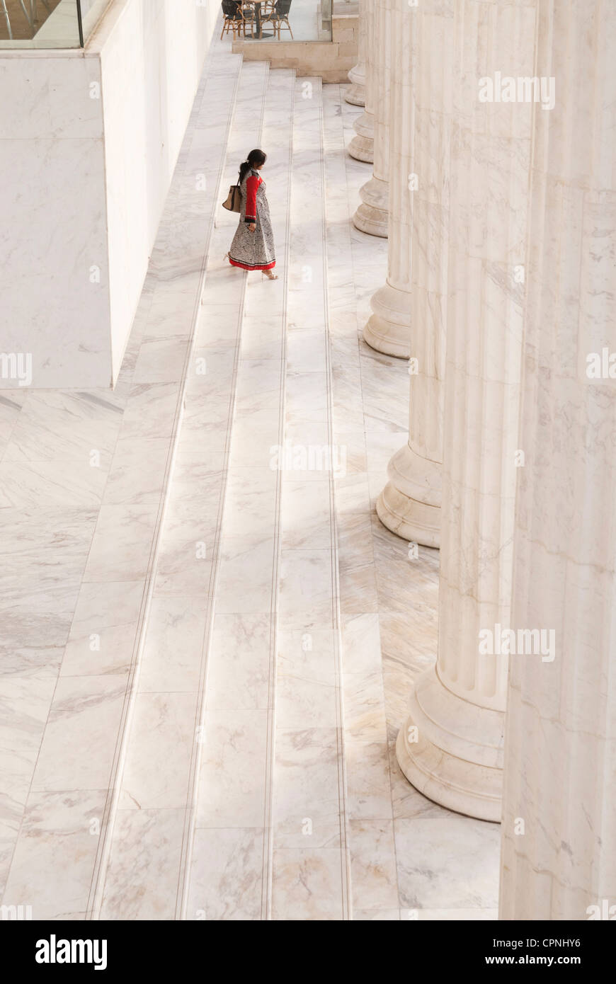 person climbing steps next to columns Stock Photo - Alamy
