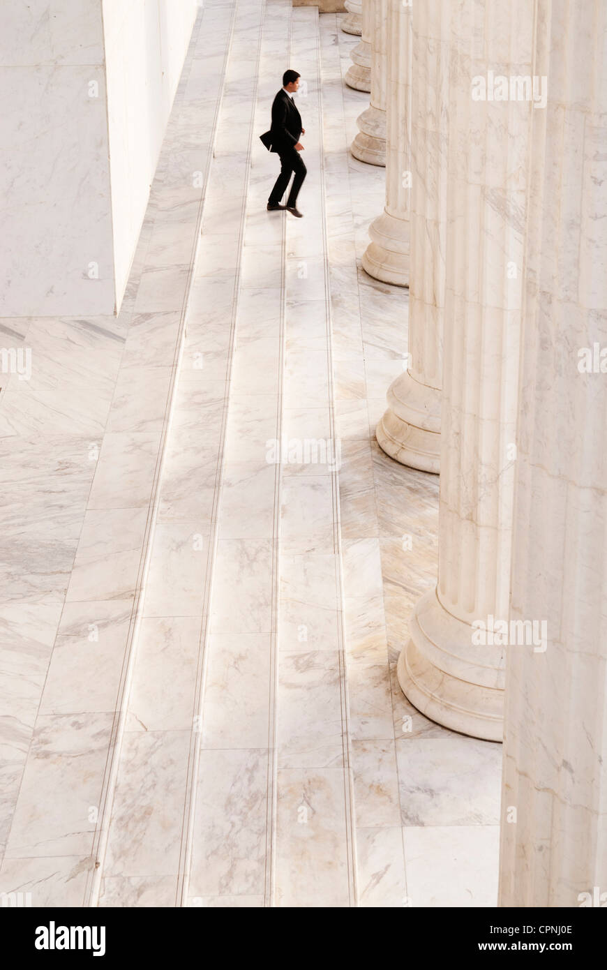 Woman steps columns hi-res stock photography and images - Alamy