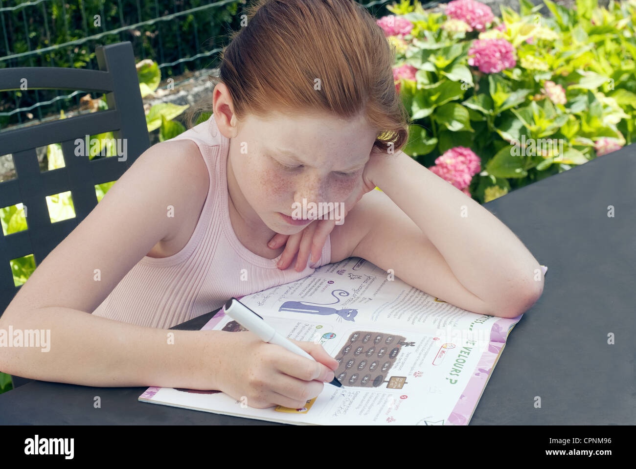 CHILD DOING HOMEWORK OUTDOORS Stock Photo - Alamy