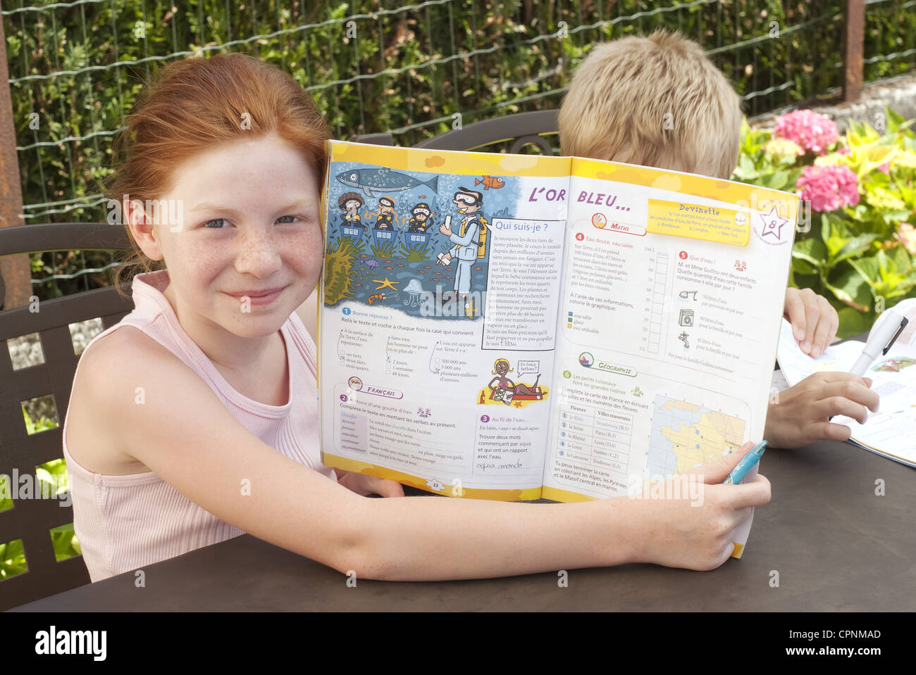 CHILD DOING HOMEWORK OUTDOORS Stock Photo - Alamy
