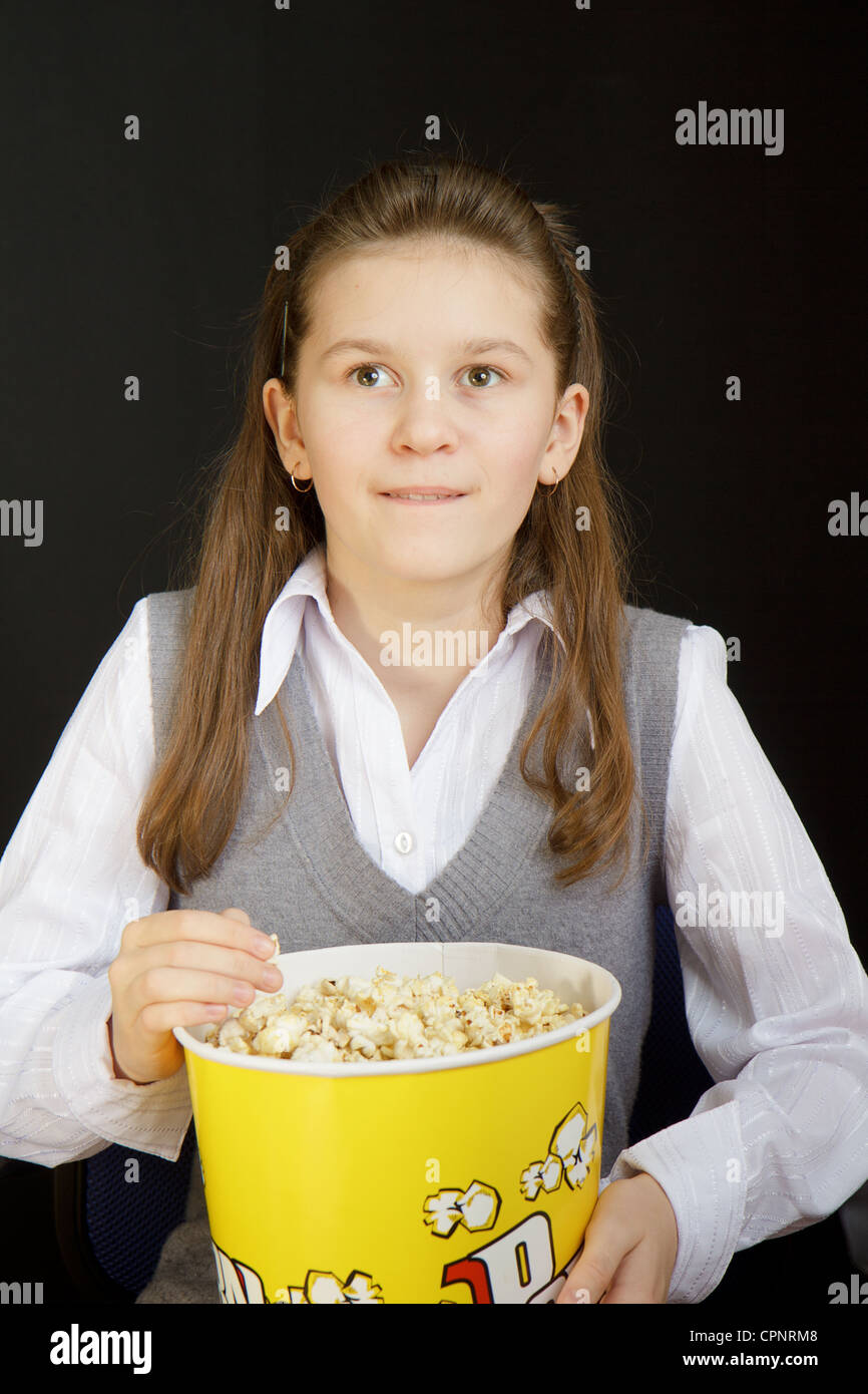 girl with popcorn on a black background Stock Photo - Alamy