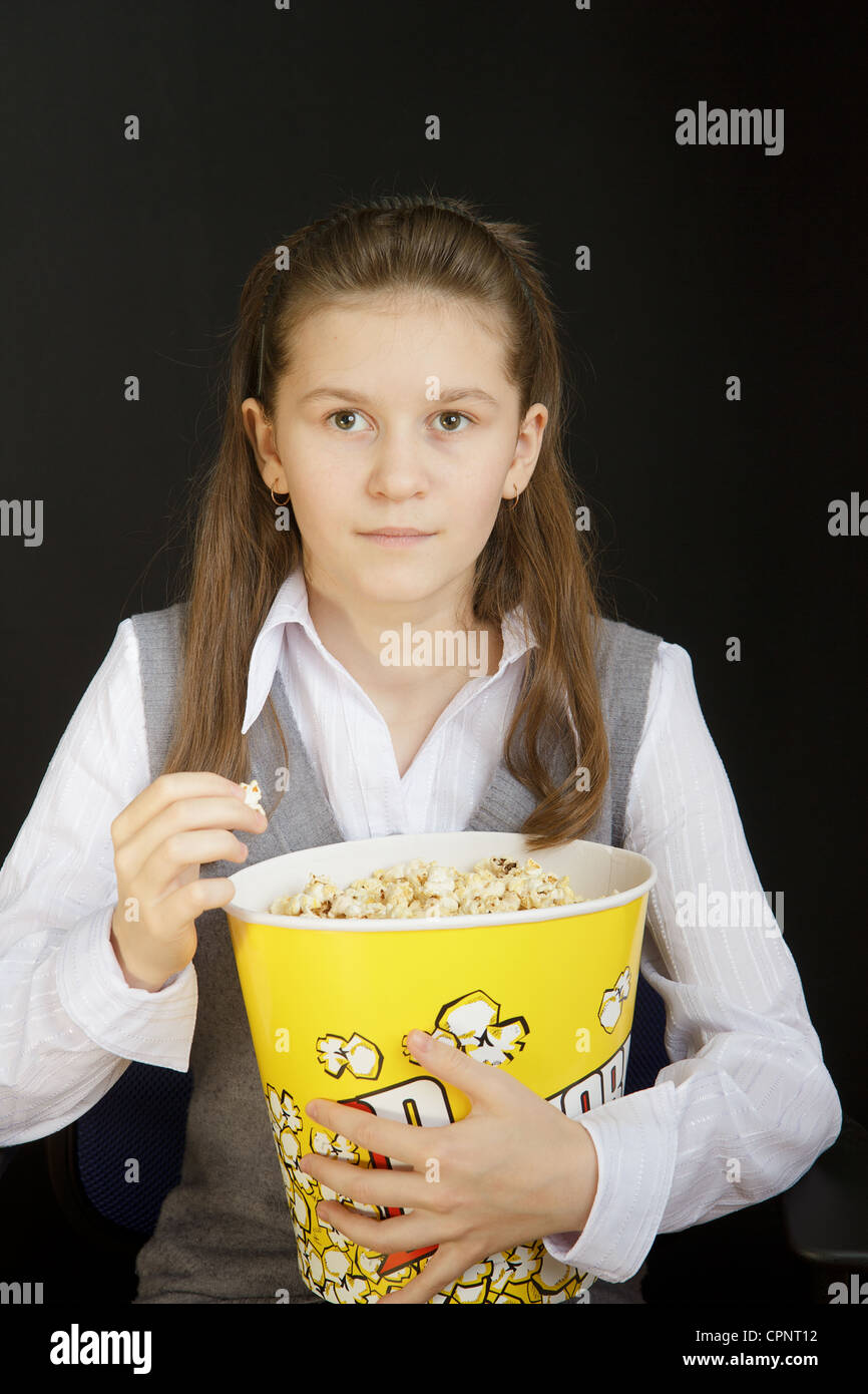girl with popcorn on a black background Stock Photo - Alamy