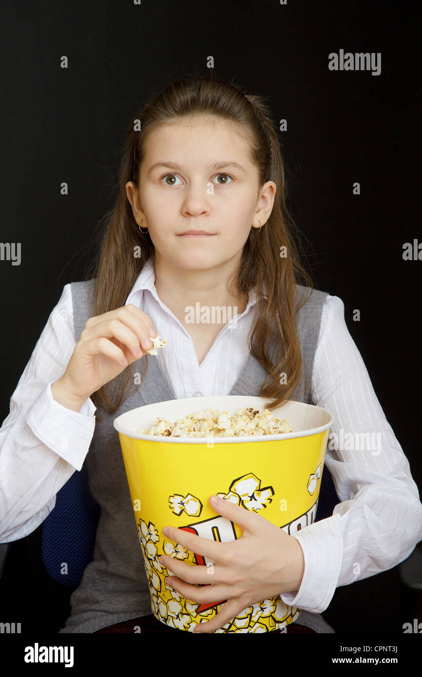 girl with popcorn on a black background Stock Photo - Alamy