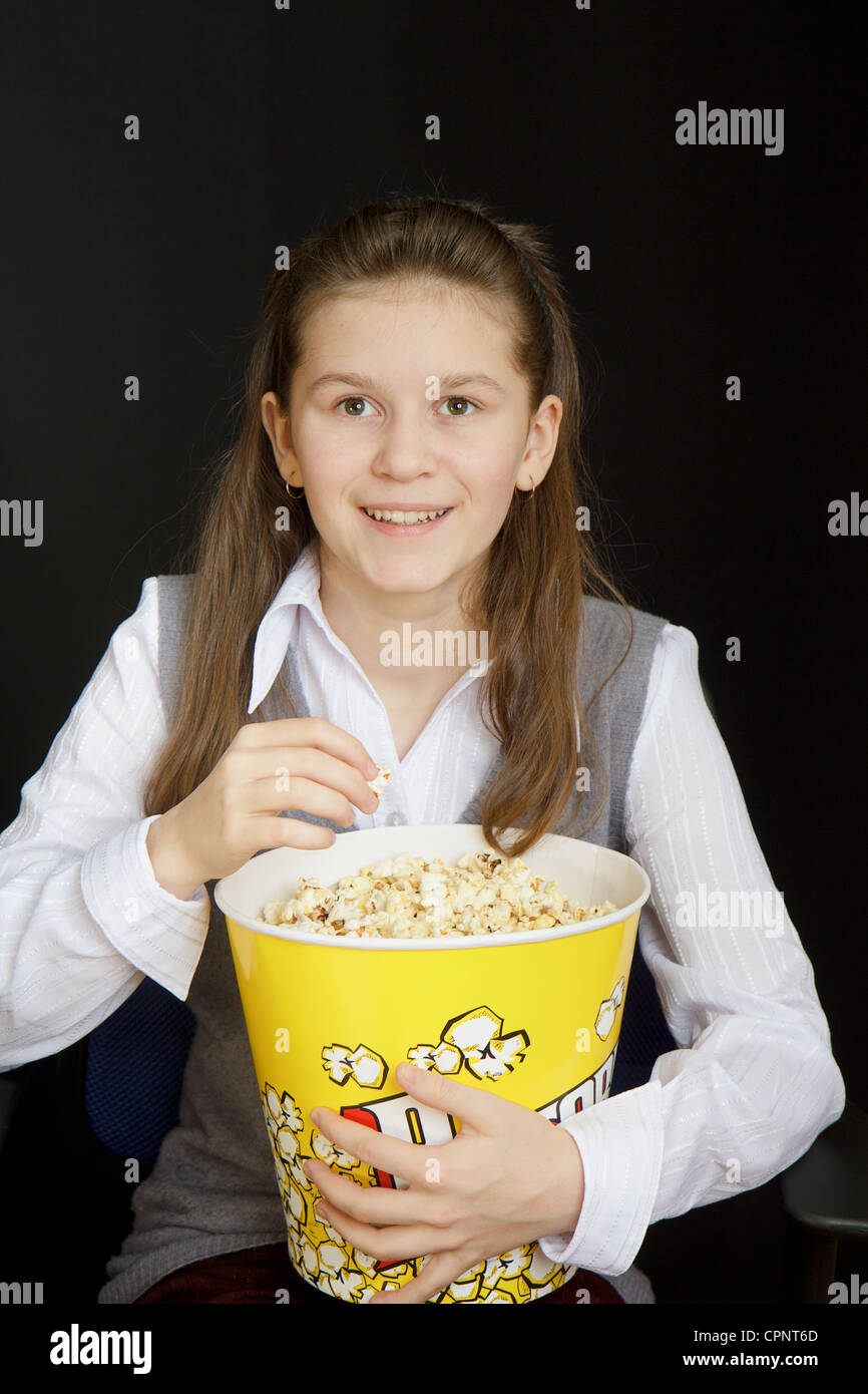 girl with popcorn on a black background Stock Photo - Alamy