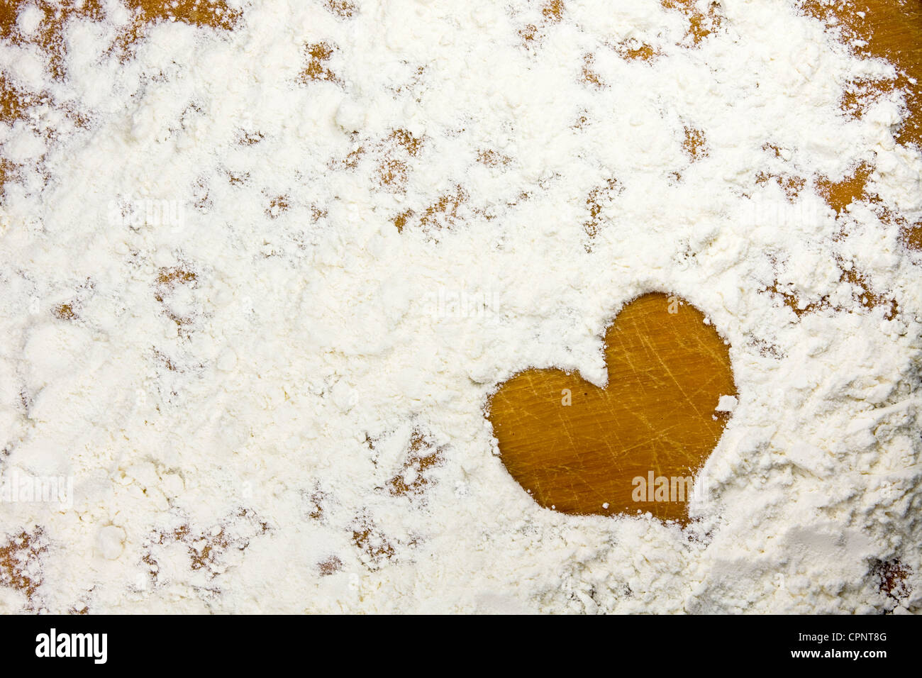 Heart shape in flour on board hi-res stock photography and images - Alamy