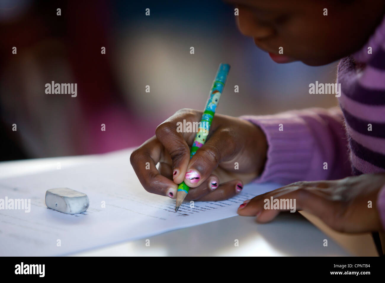 Girl writing on paper at school Stock Photo - Alamy
