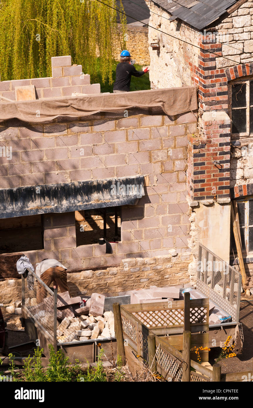 Two builders building an extension Stock Photo - Alamy