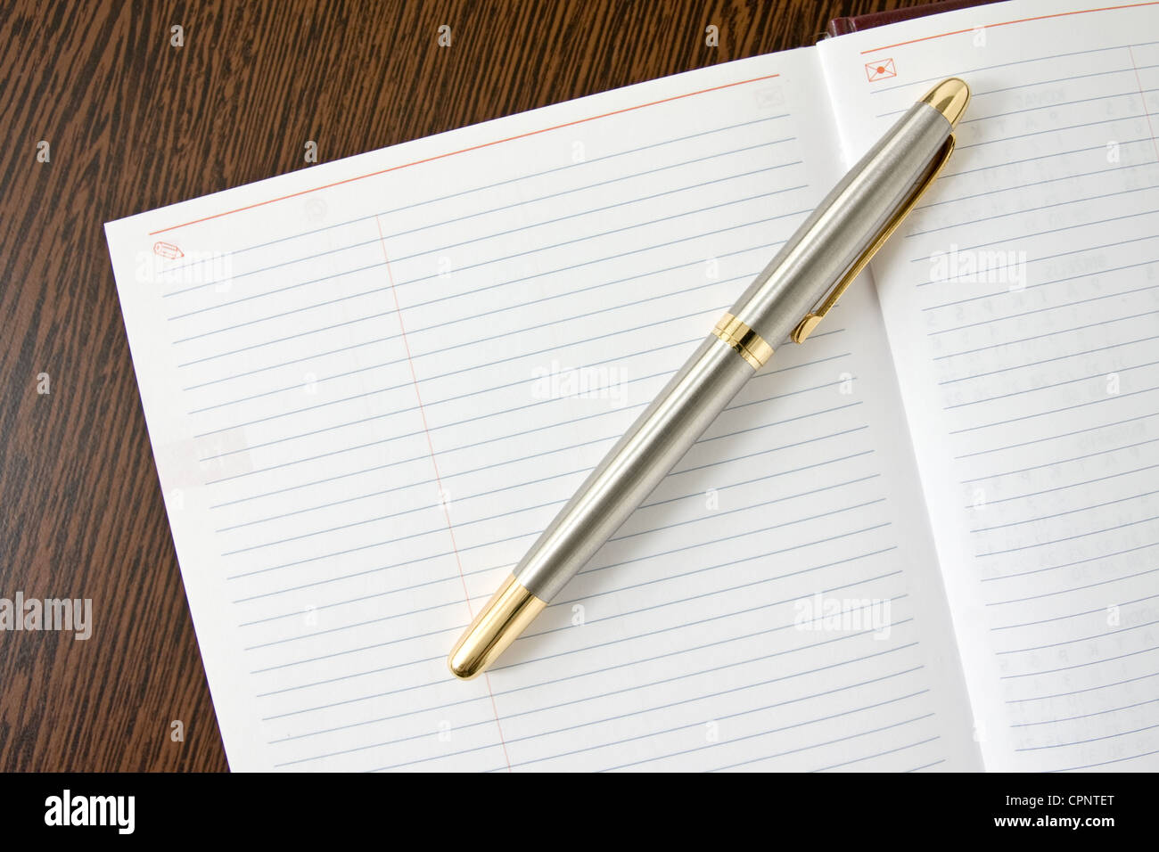 ink pen and notebook on the table Stock Photo - Alamy