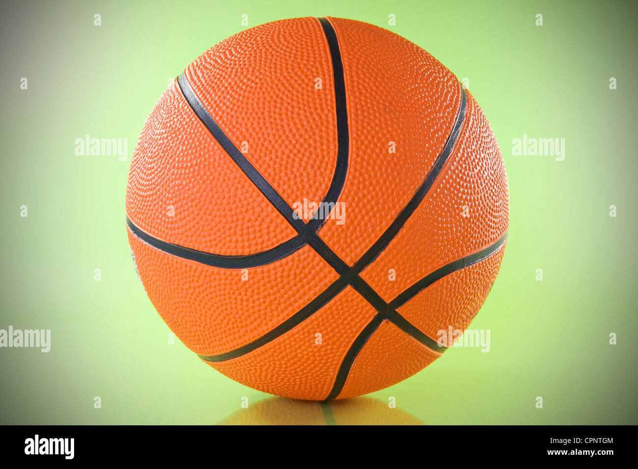 orange basketball ball over a green background Stock Photo - Alamy