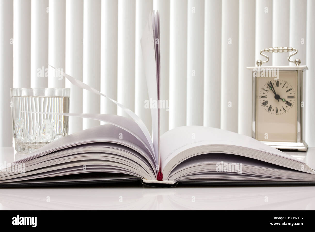 time for reading. book,clock and glass of water Stock Photo - Alamy