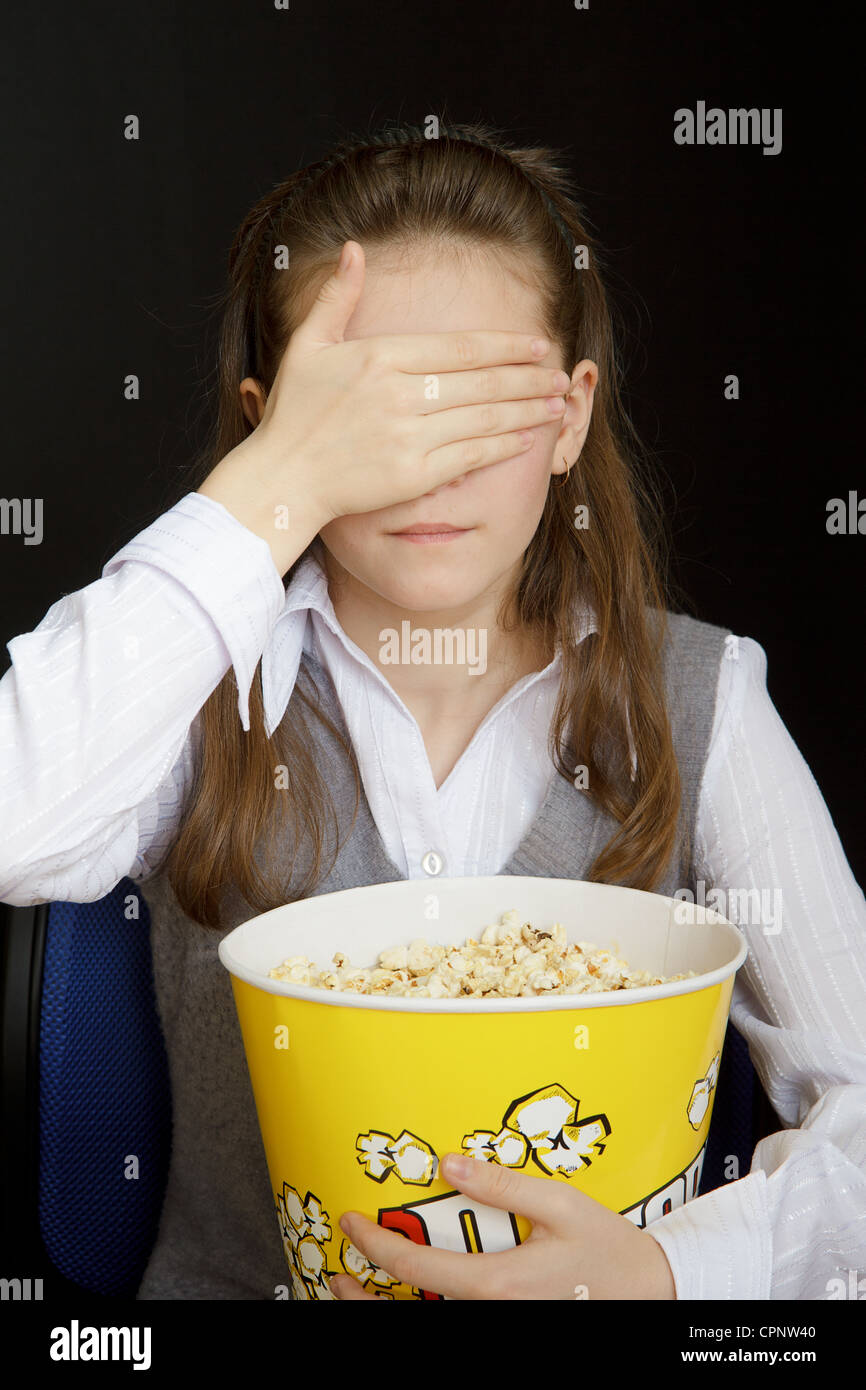 girl in a movie theater closes her eyes Stock Photo - Alamy