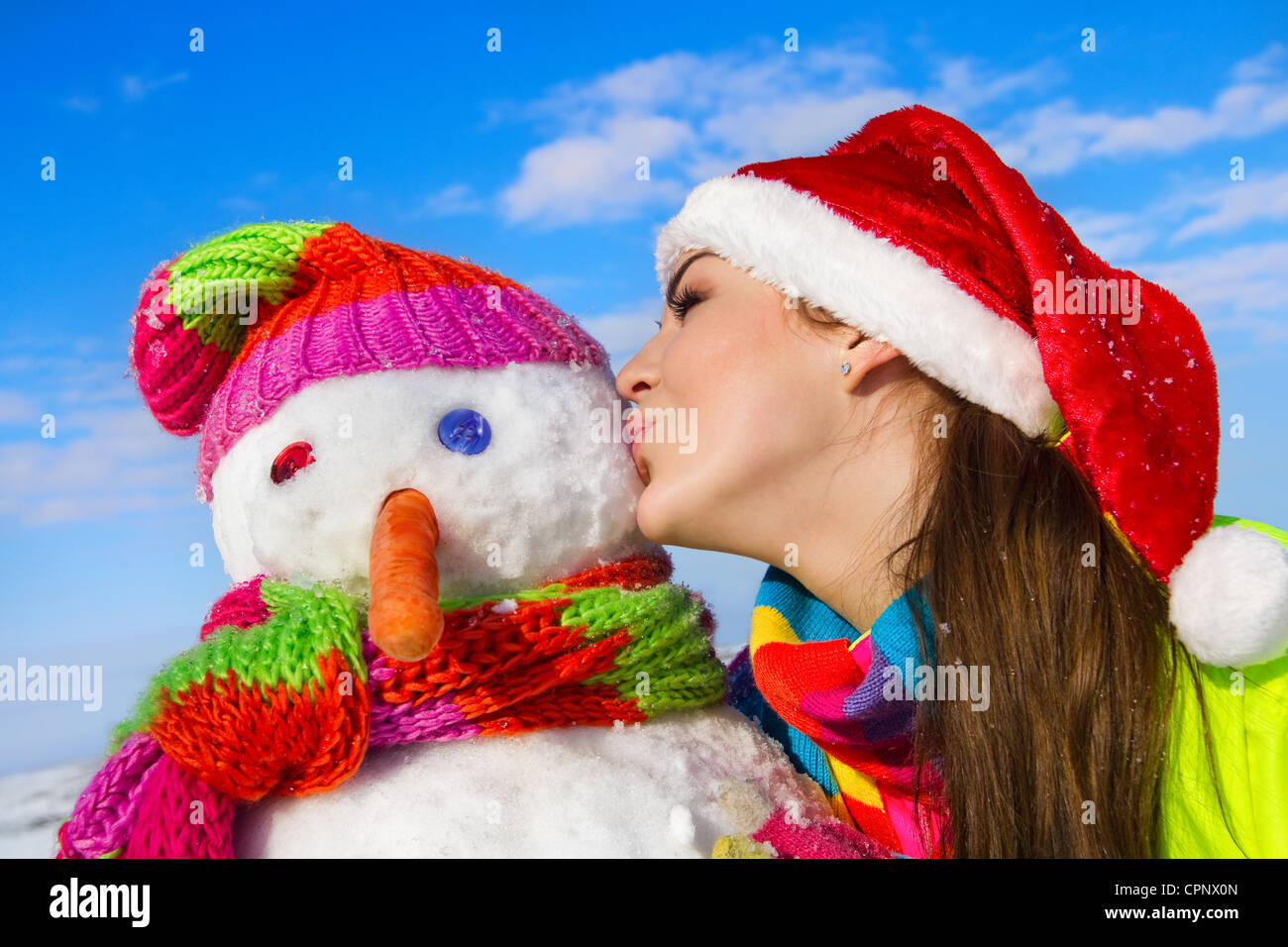 Woman is kissing snowman on a warm winter day outdoor Stock Photo - Alamy