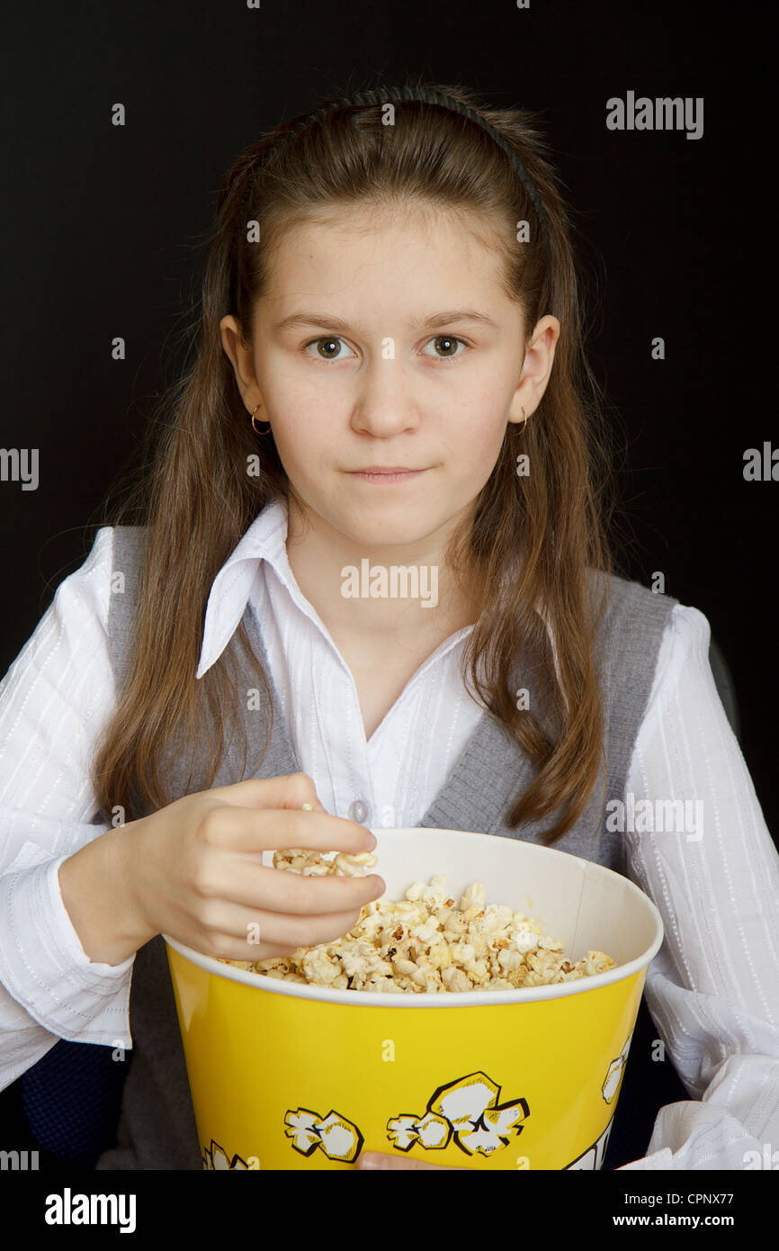 girl with popcorn on a black background Stock Photo - Alamy