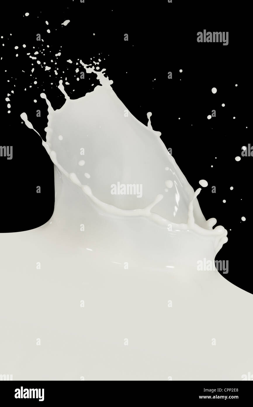 splashing milk isolated on black background Stock Photo - Alamy
