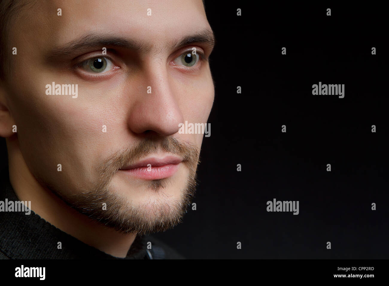 face of the young unshaven man in a black background Stock Photo - Alamy