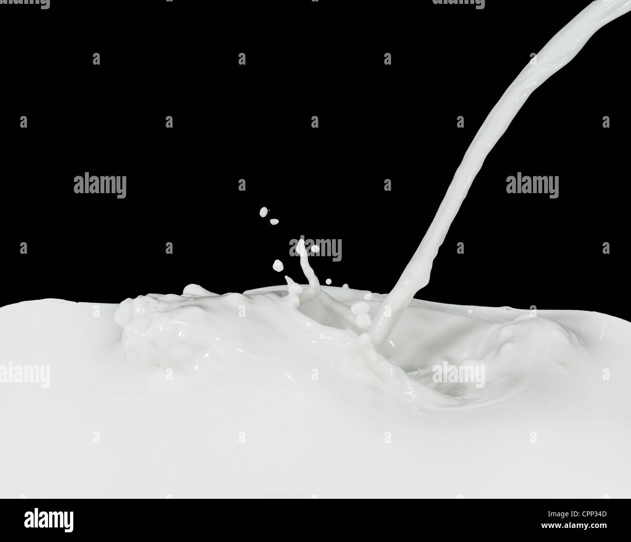splashing milk isolated on black background Stock Photo - Alamy