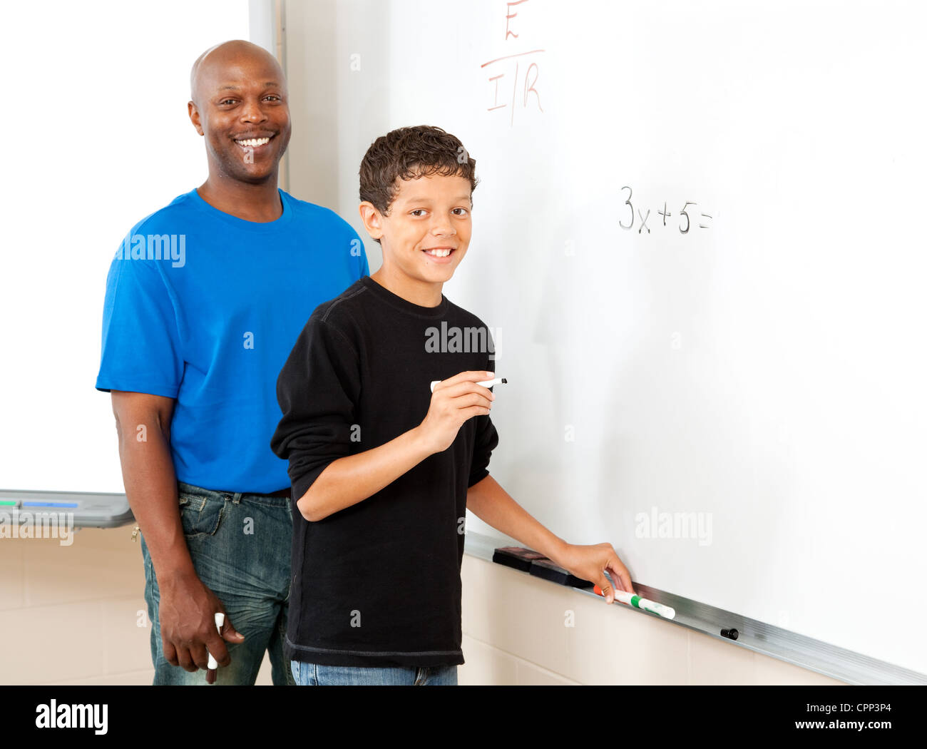 African American teacher and student doing simple algebra equation at ...