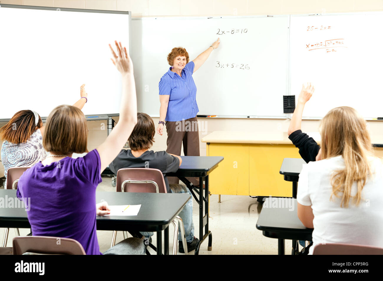 Students raise their hands to solve a problem in algebra class Stock ...
