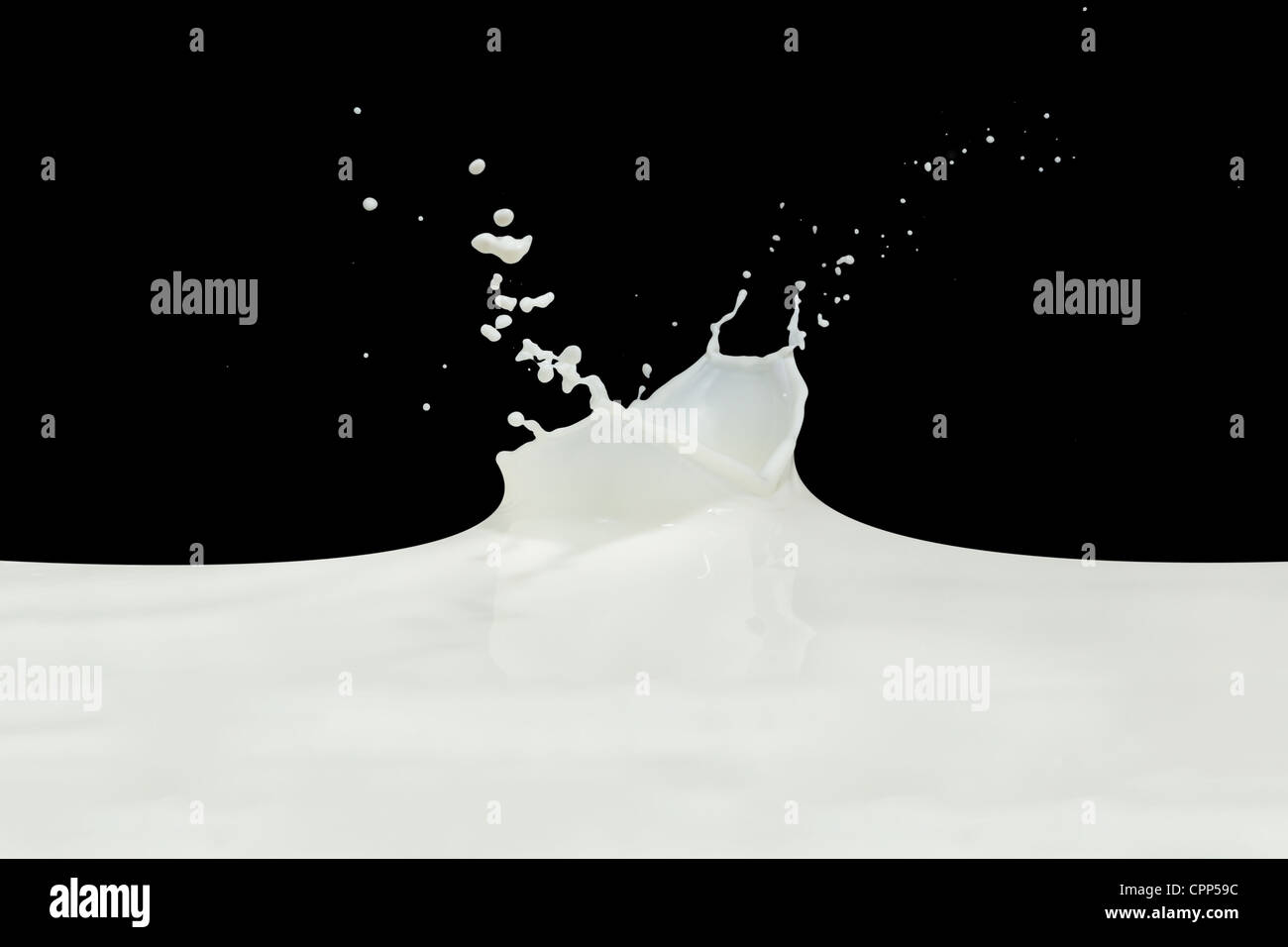 splashing milk isolated on black background Stock Photo - Alamy