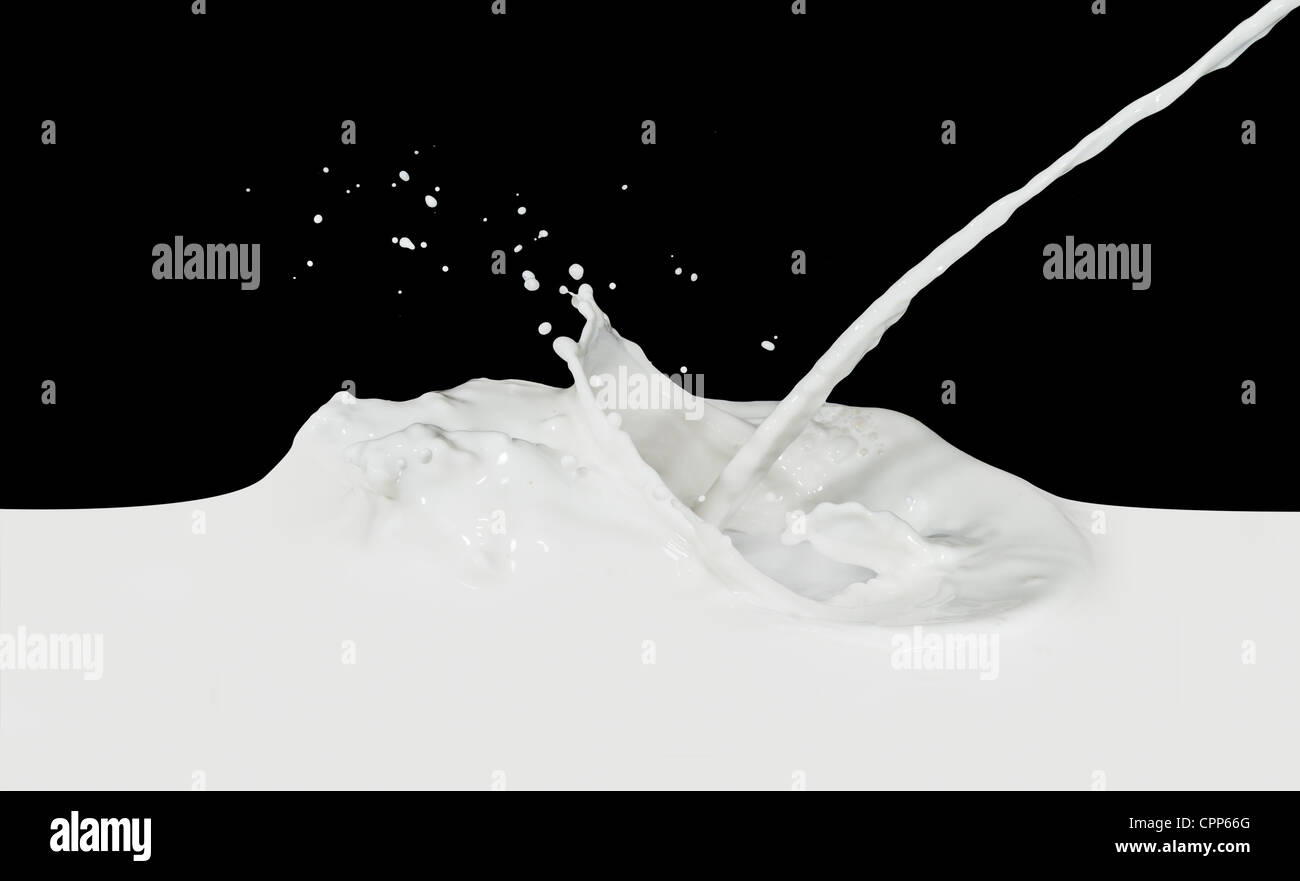 splashing milk isolated on black background Stock Photo - Alamy